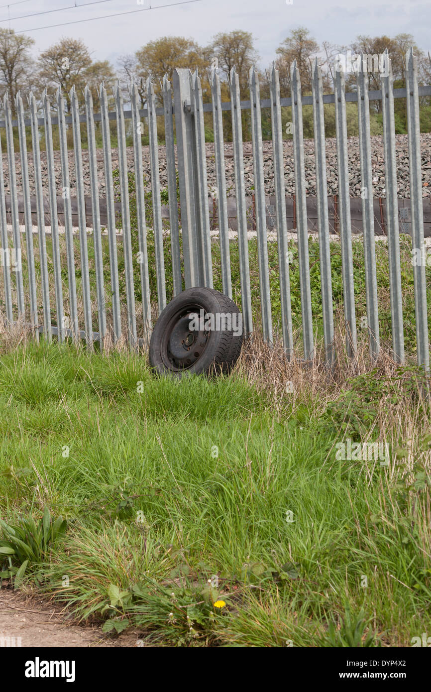 A fly tipped car tyre near a railway line in the UK Stock Photo - Alamy