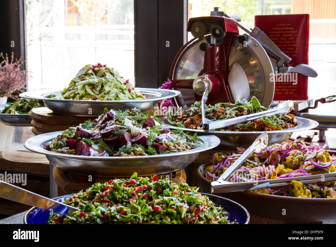 A selection of salads on display in a restaurant window with focus on ...