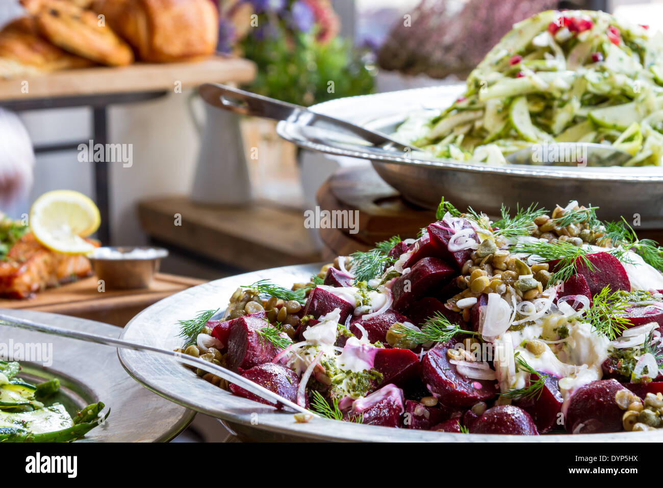 A selection of salads on display in a restaurant window with focus on ...