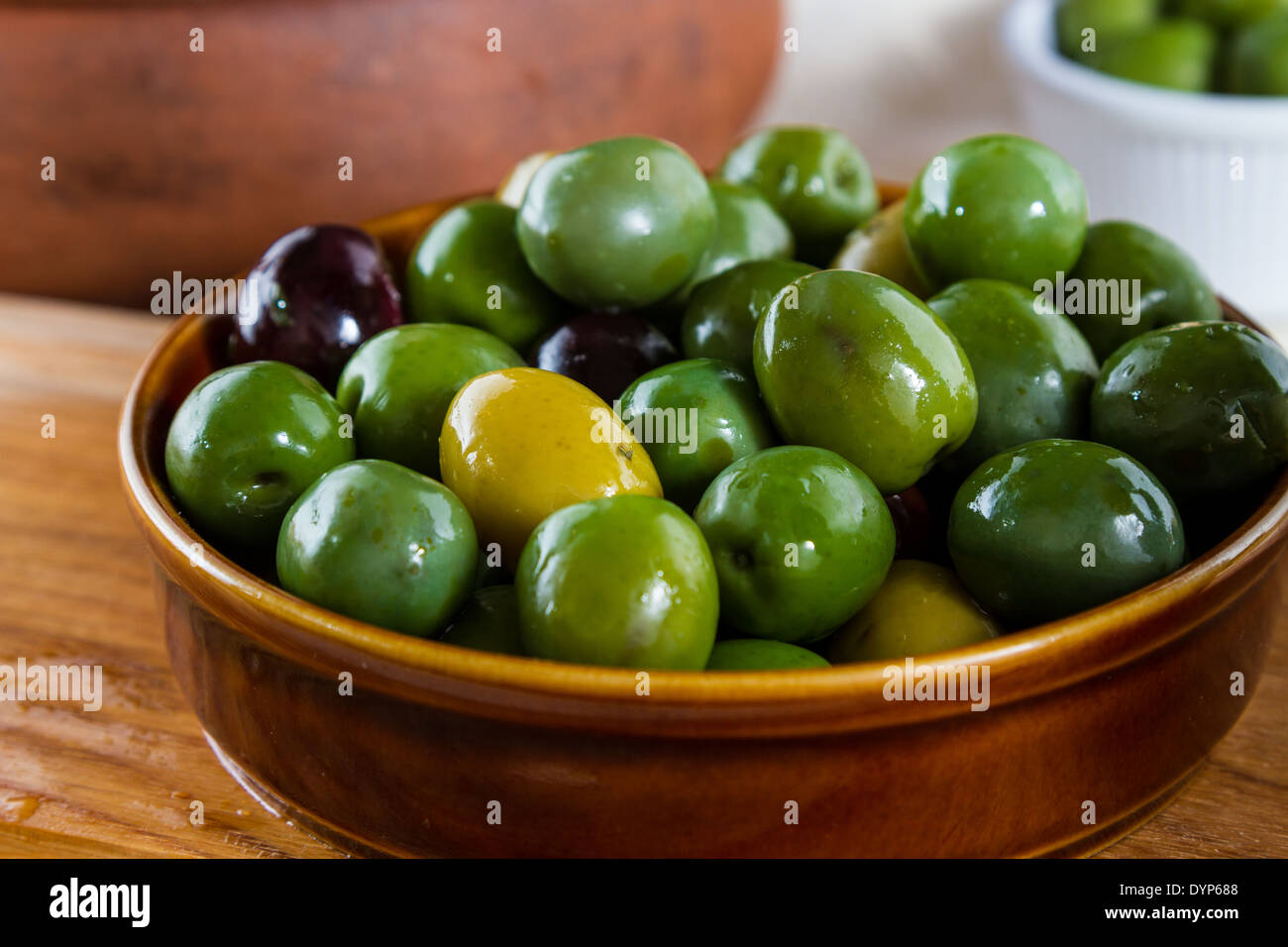 Lovely, juicy, fat olives from the Mediterranean, in rustic bowl Stock ...