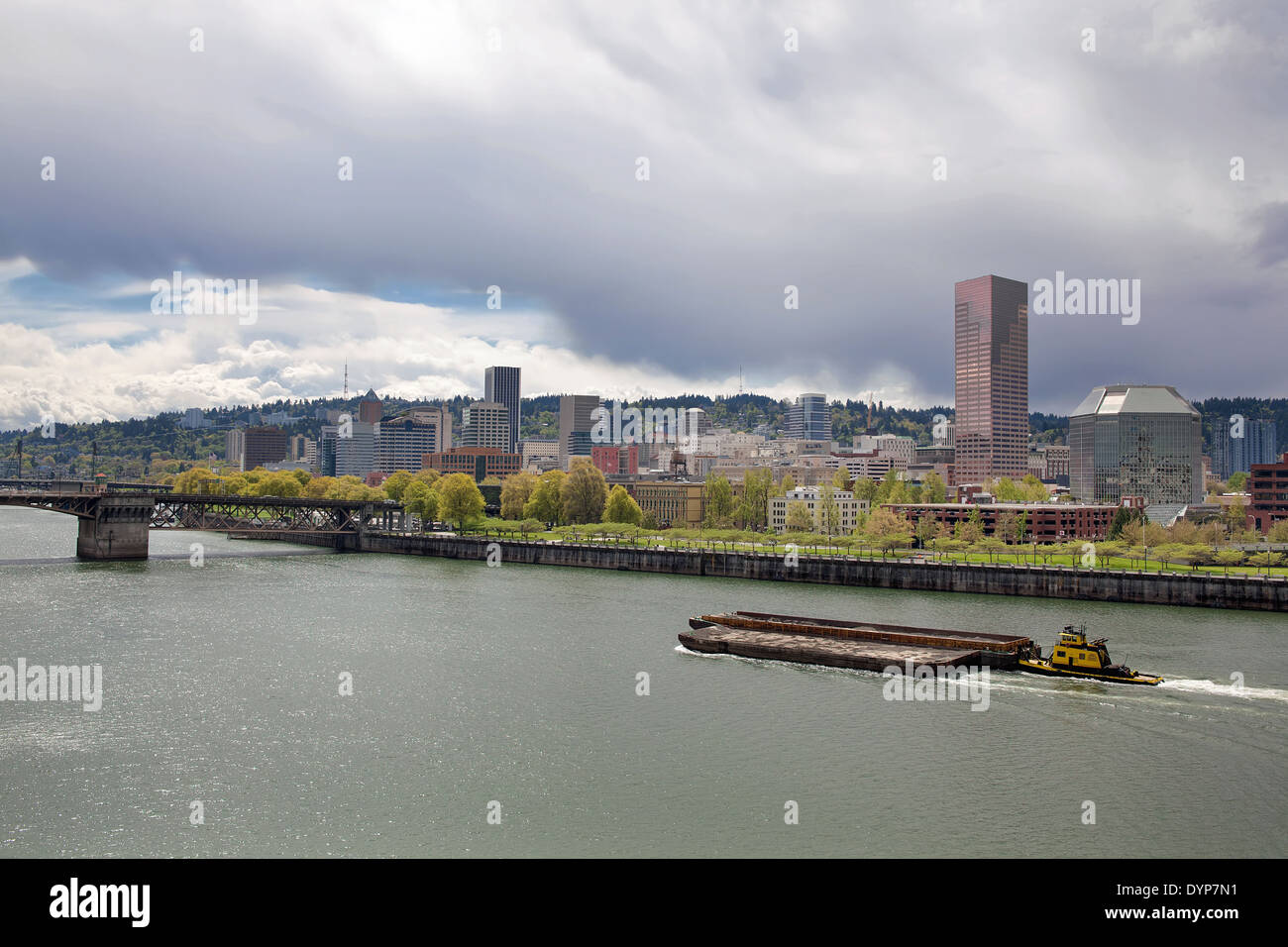 Tugboat Pushing Barge Along Willamette River with Portland Oregon City ...