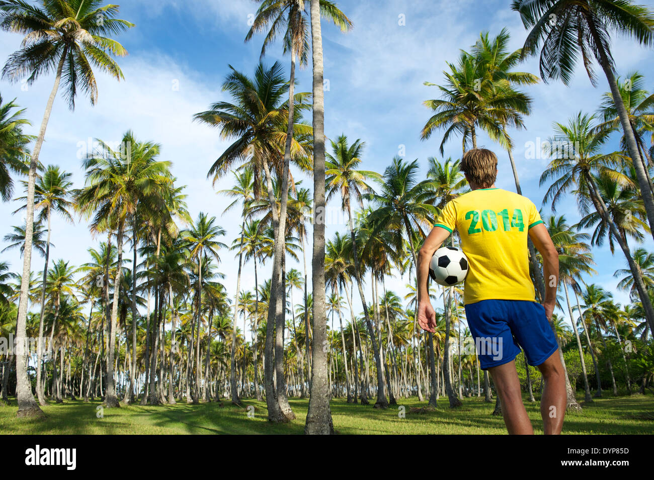Brazilian football player in Brazil colors uniform standing in grove of ...