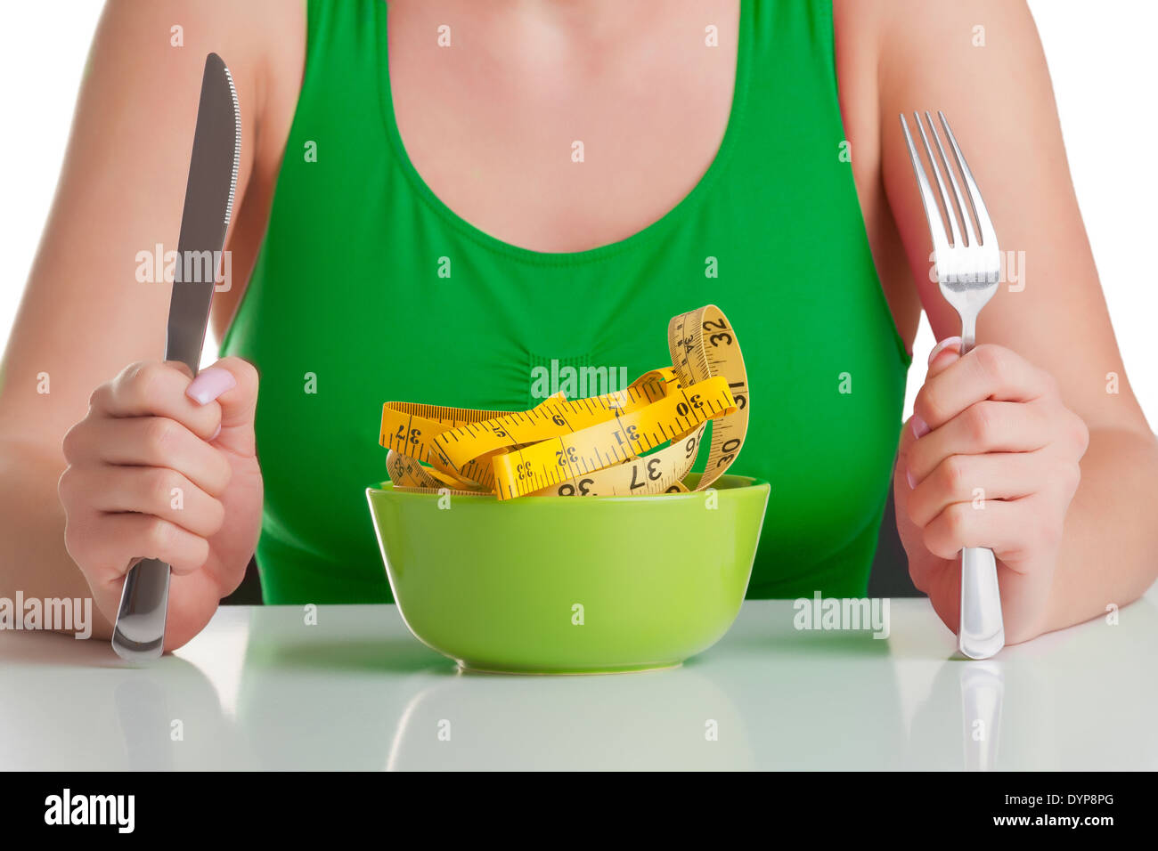 Concept image of a woman on a diet, eating a measuring tape, isolated ...