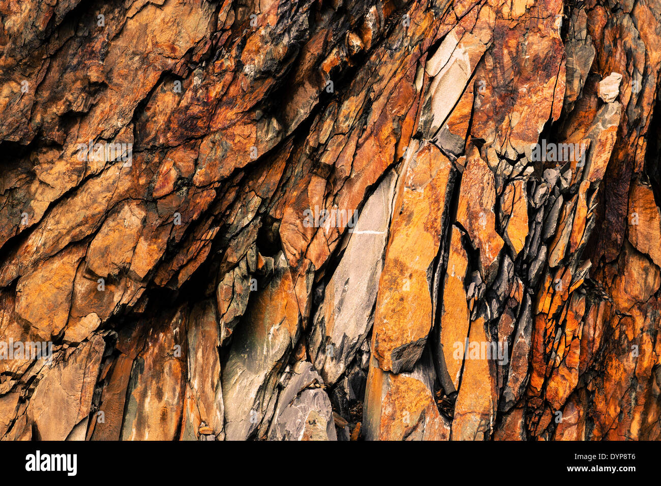 Abstract rock patterns flaking off a cliff by the sea Stock Photo - Alamy