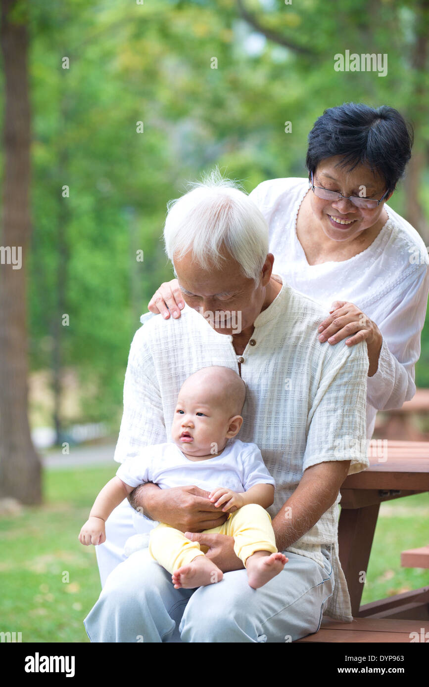 chinese grandfather playing with baby grandson at outdoor Stock Photo ...
