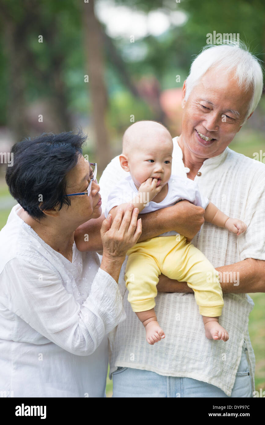 chinese grandfather playing with baby grandson at outdoor Stock Photo ...