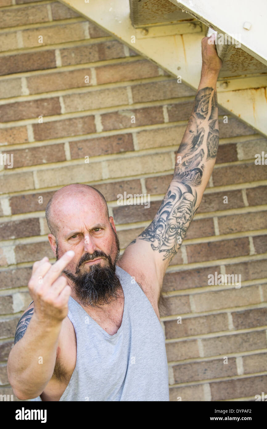 Angry, Caucasian man of German decent giving the bird to someone or ...