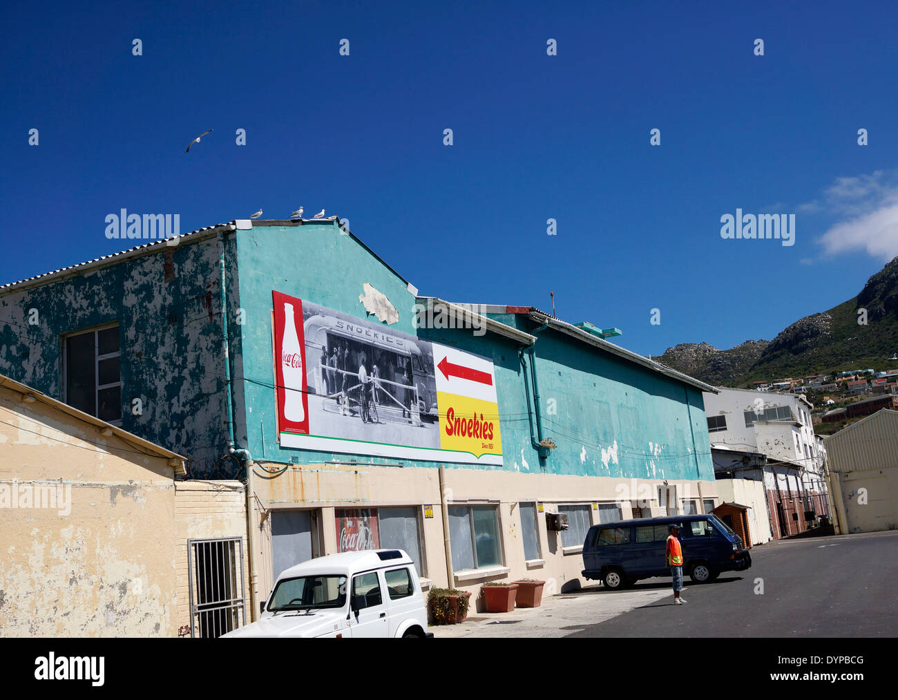 Car guard in parking area of Snoekies take away and seafood restaurant ...