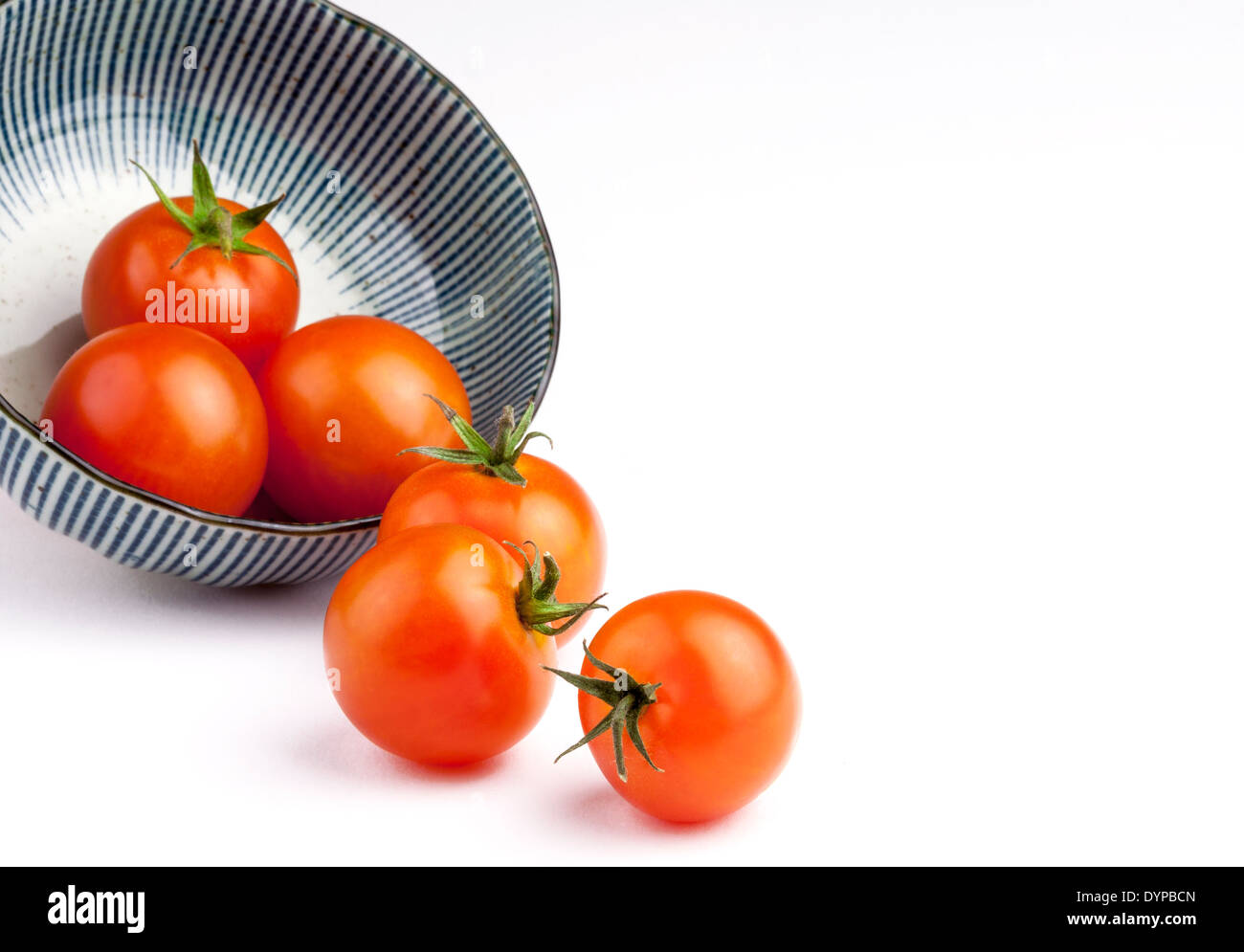 Half empty bowl of tomatoes isolated on white background with copy ...