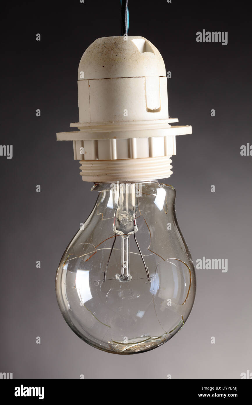 a destroyed bulb on a grey background Stock Photo - Alamy