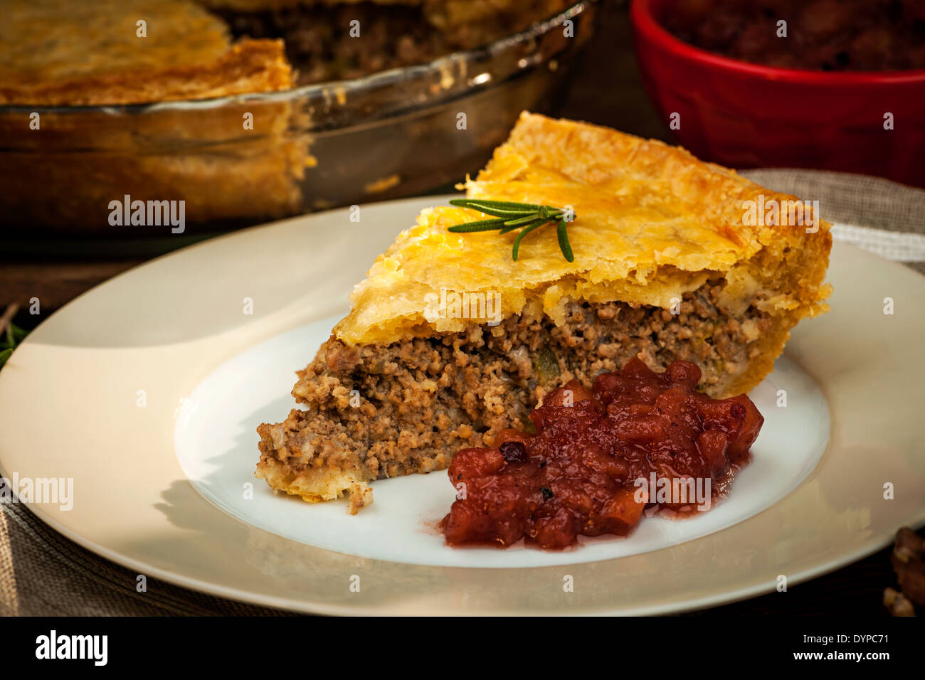 Slice of traditional pork meat pie Tourtiere with apple and cranberry ...
