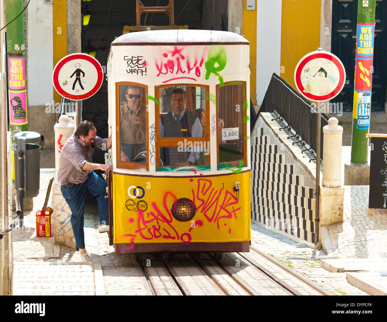 Passenger boarding the Elevador da Bica funicular for its steep ascent ...