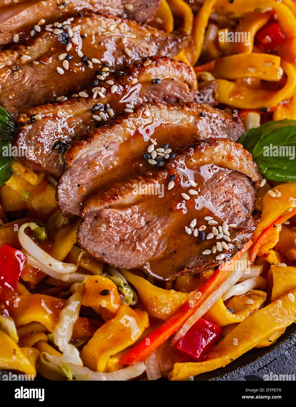 Fried dack meat with egg noodles closeup Stock Photo - Alamy