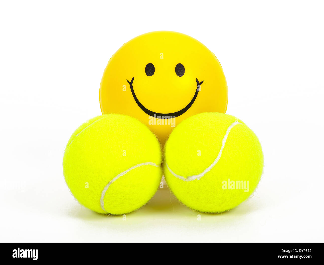 smiling tennis ball and two normal balls Stock Photo - Alamy