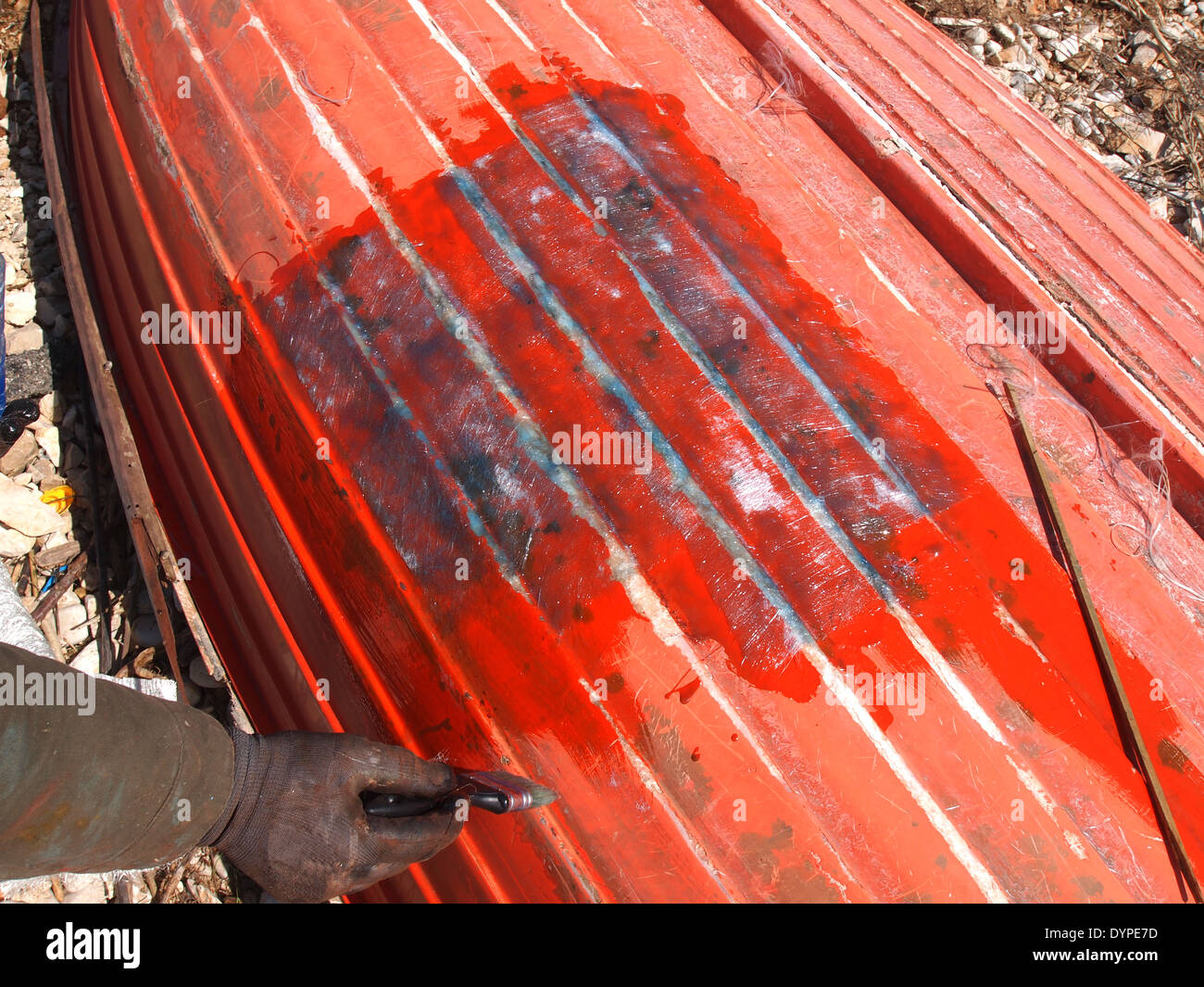 repairing of old red plastic boat Stock Photo - Alamy