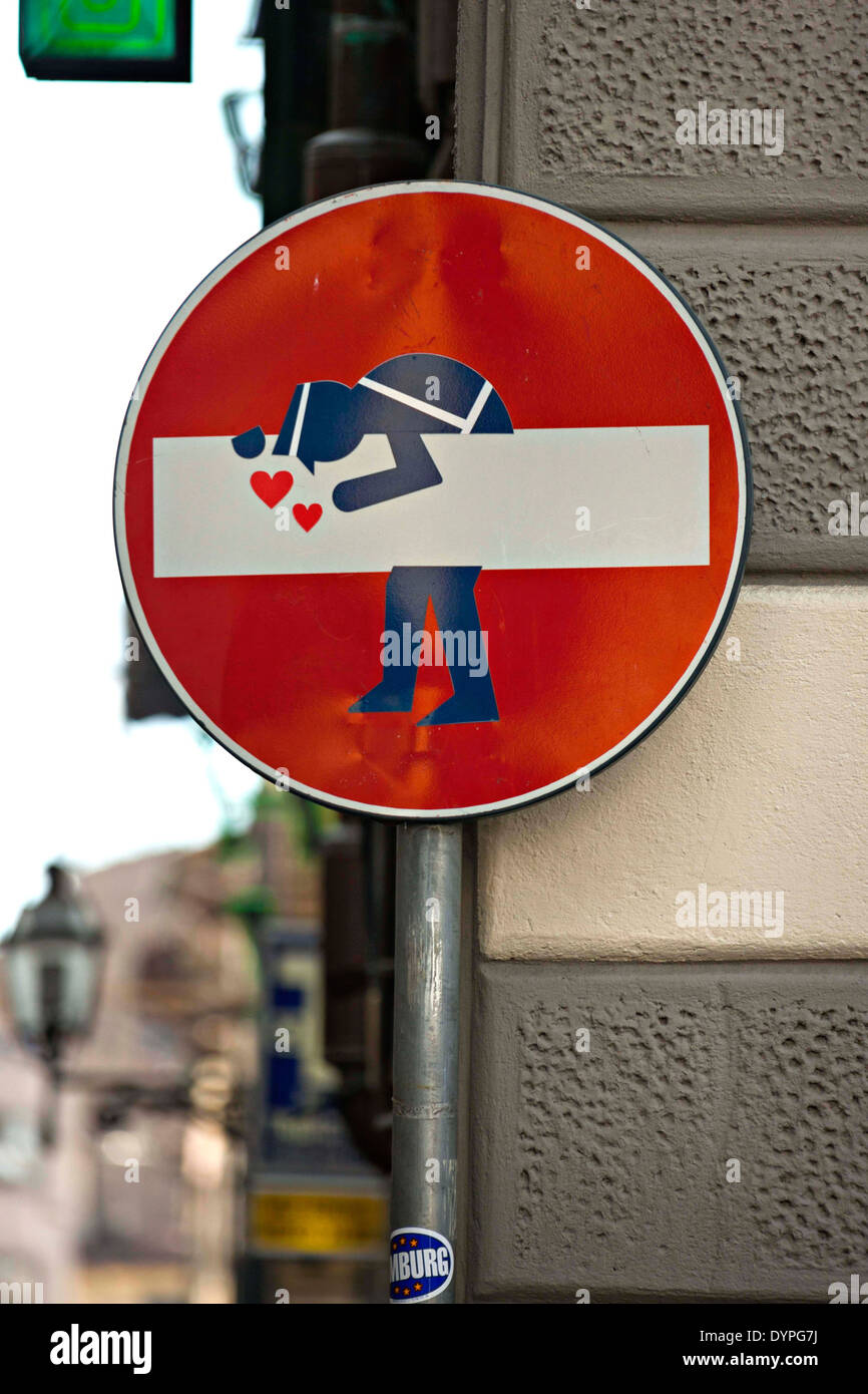 Graffiti on a no entry road traffic sign with love hearts and policeman ...