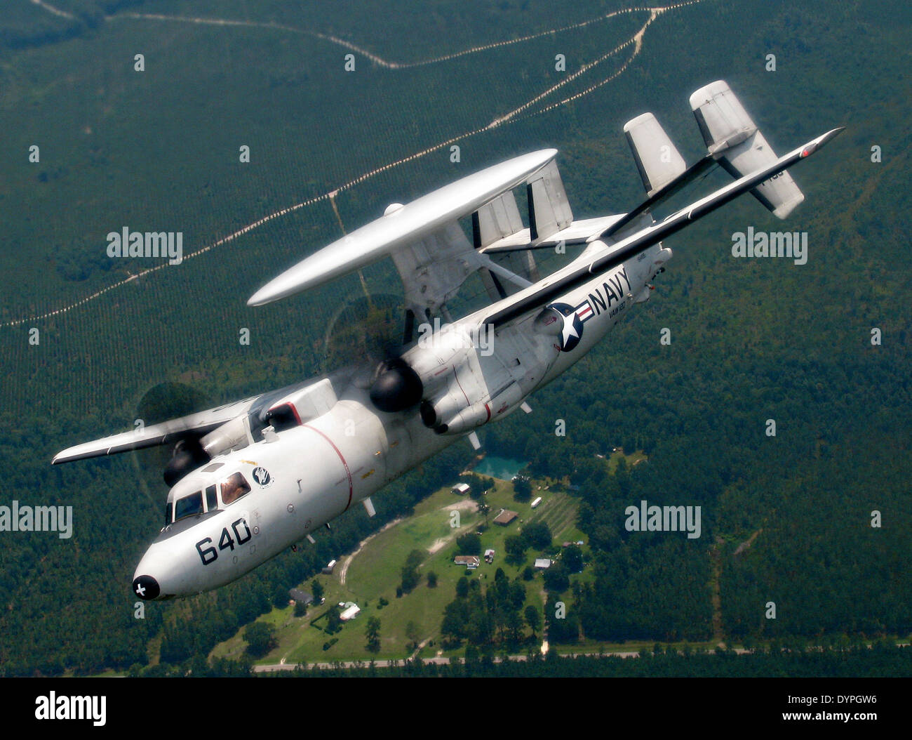 A US Navy E-2C Hawkeye airborne early warning aircraft banks during ...