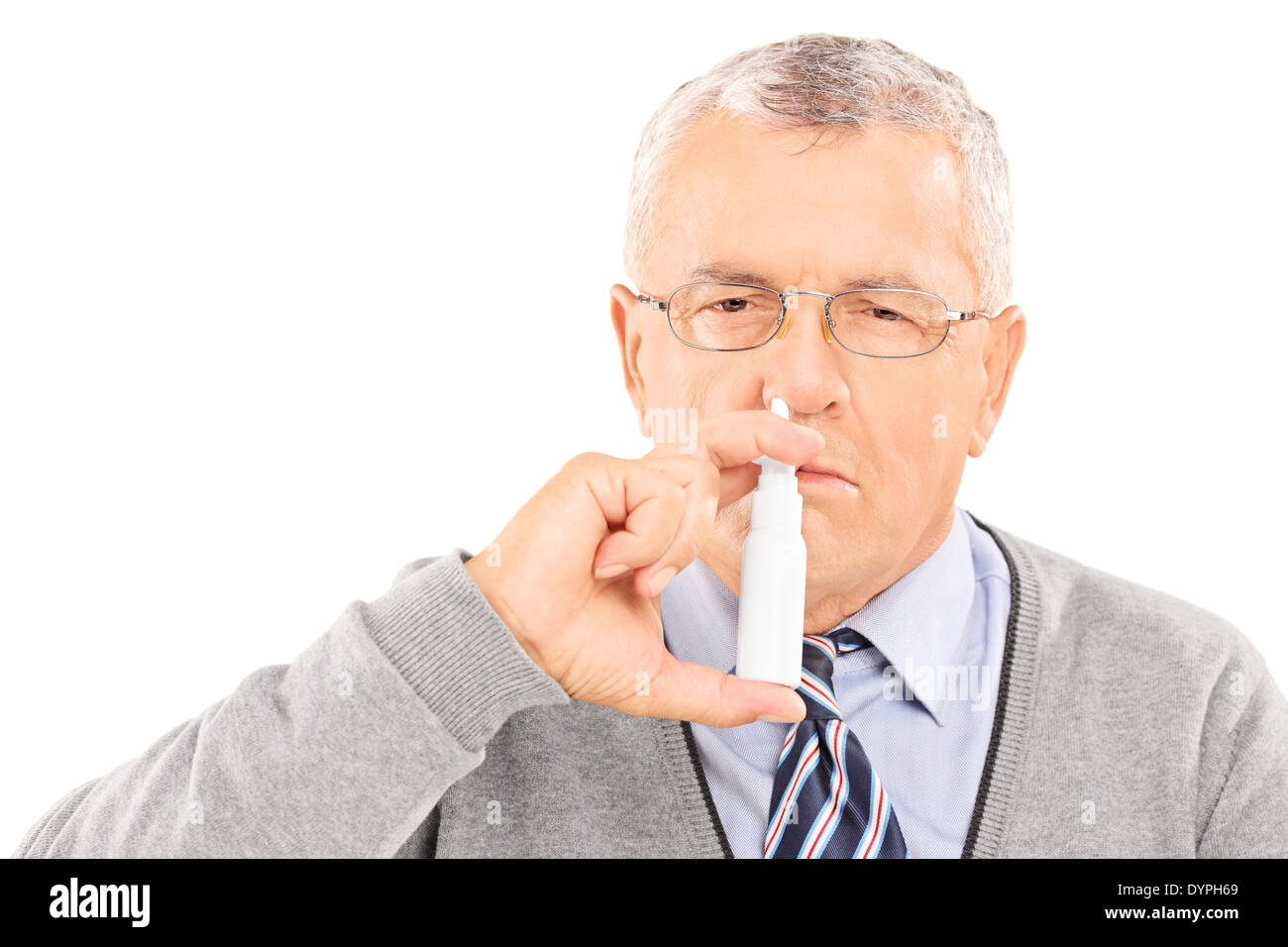 Senior man spraying medication in his nose Stock Photo - Alamy