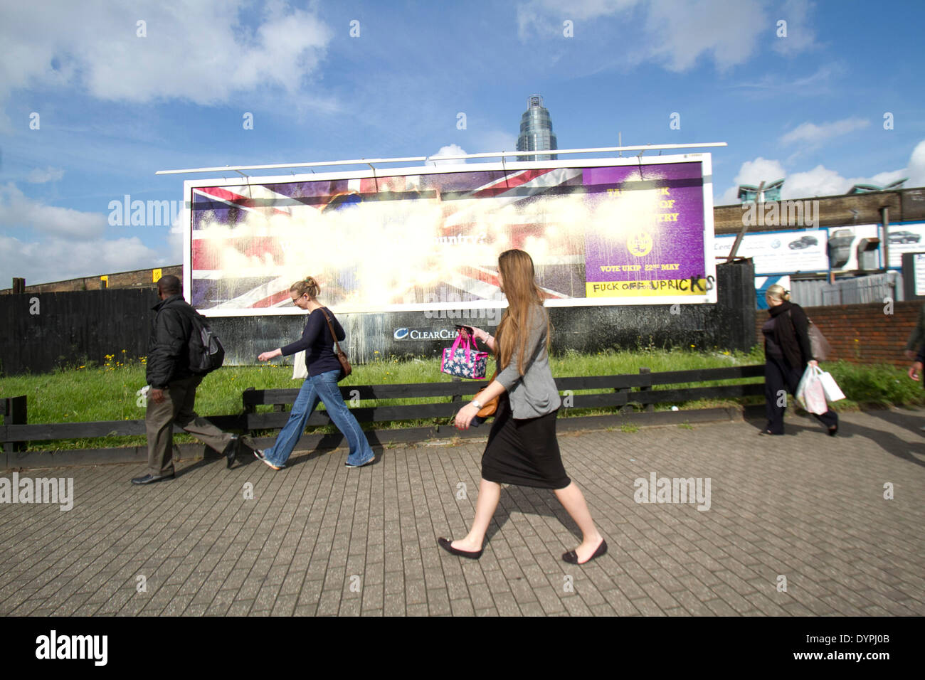 London UK. 24th April 2014. Pedestrians walk past A (UKIP) United ...