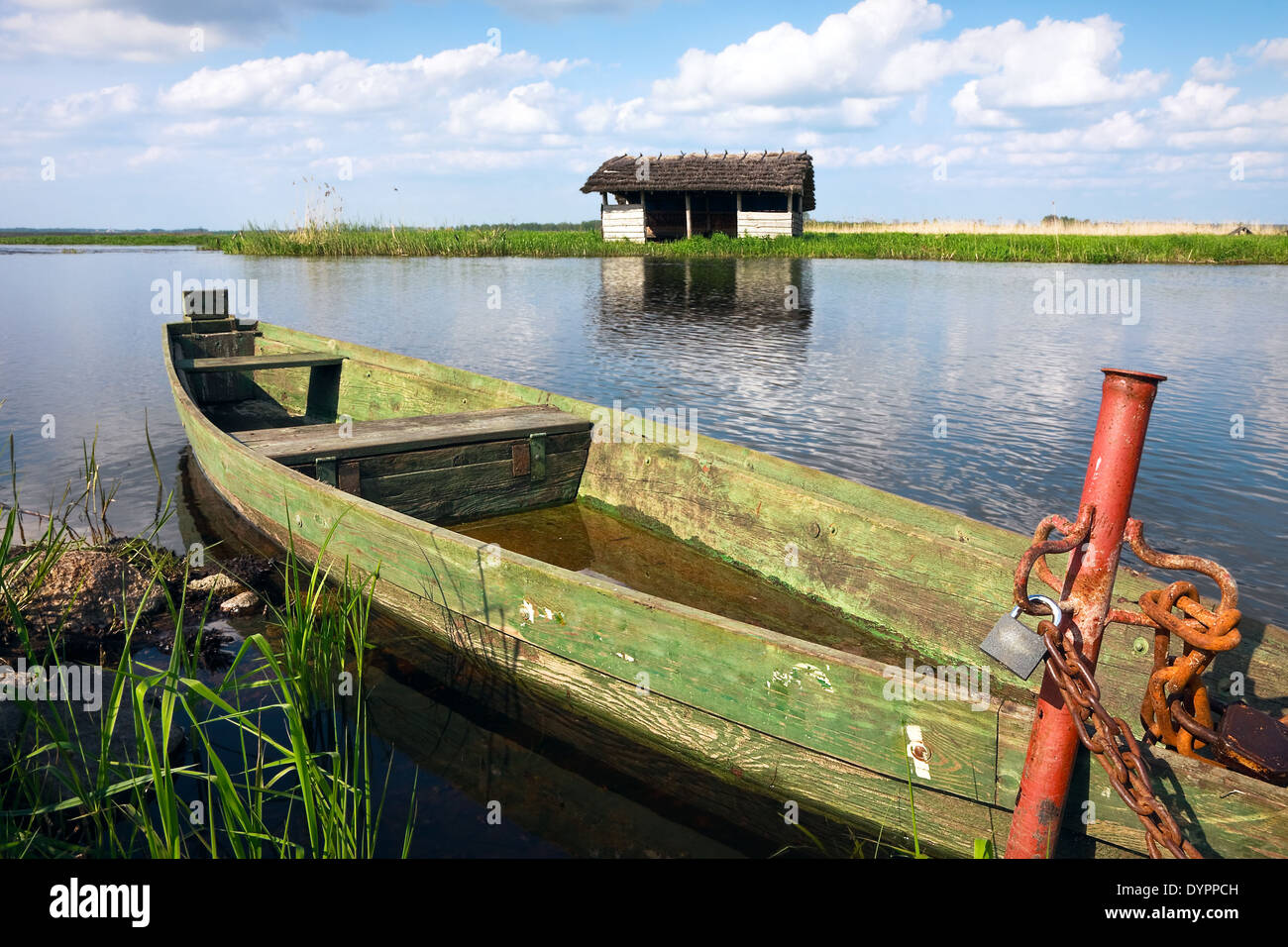 Green boat at the lake shore Stock Photo - Alamy