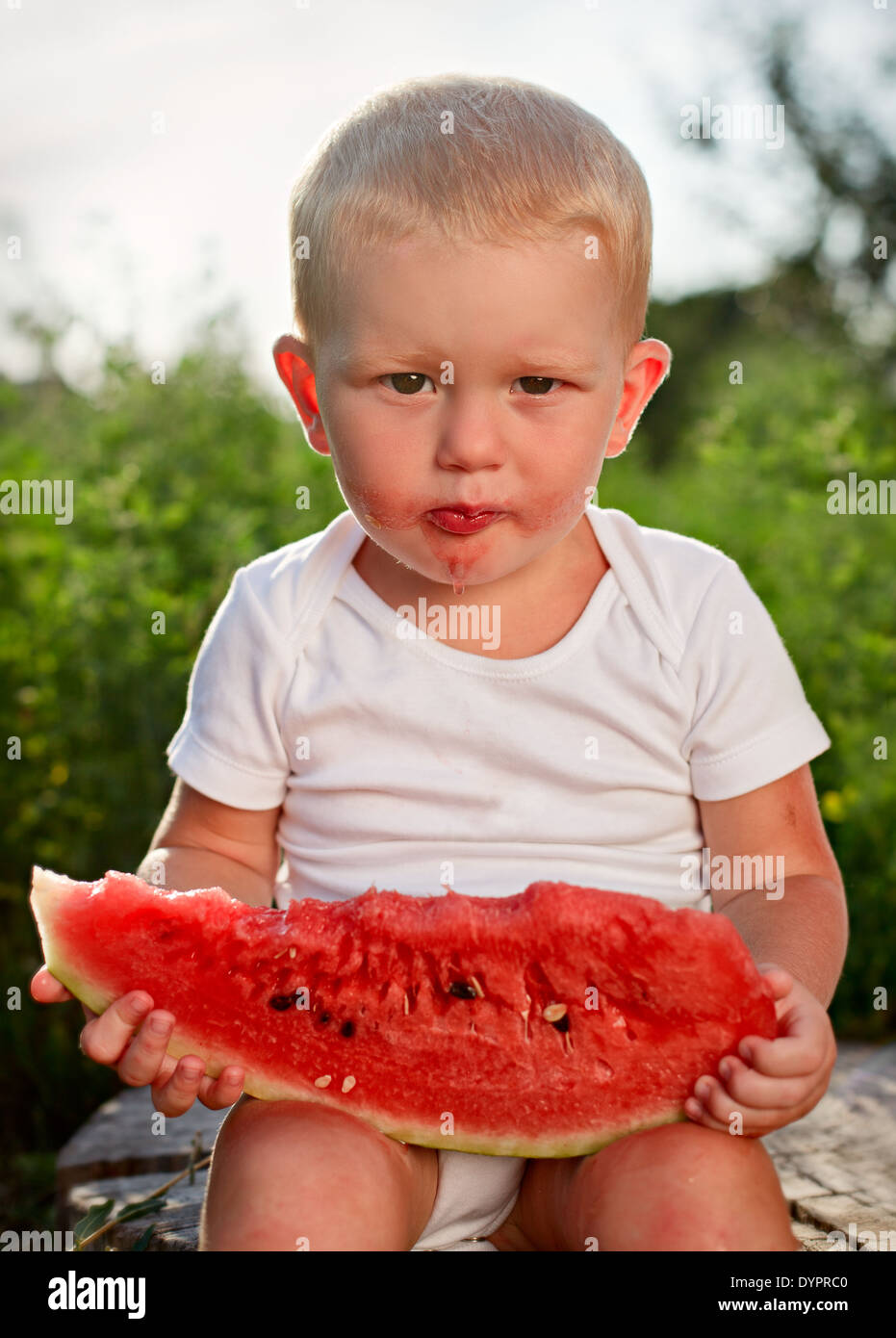little baby eating watermelon outdoors Stock Photo - Alamy