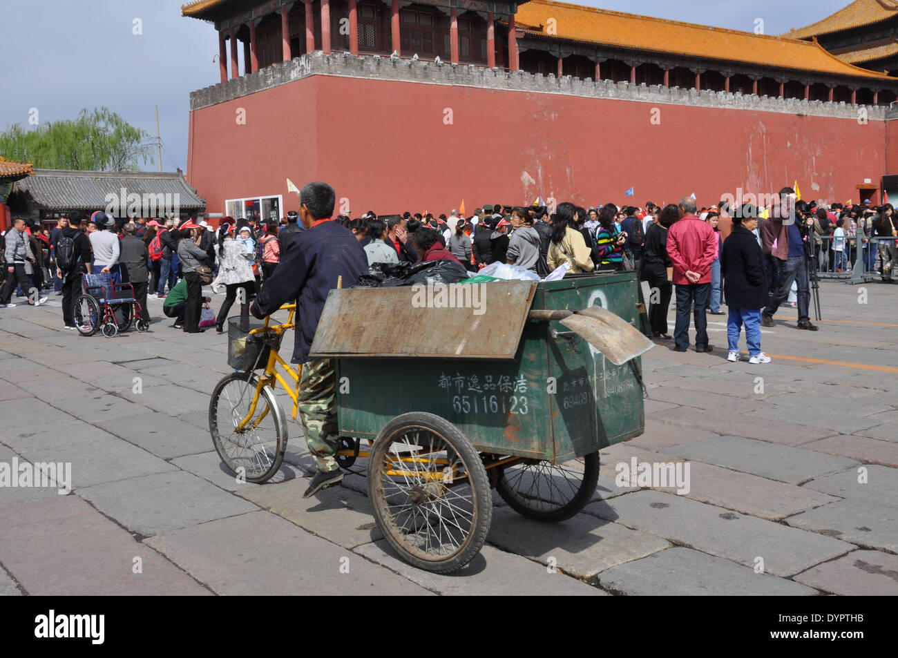 A worker riding a work tricycle with a cart at the Meridian Gate of ...