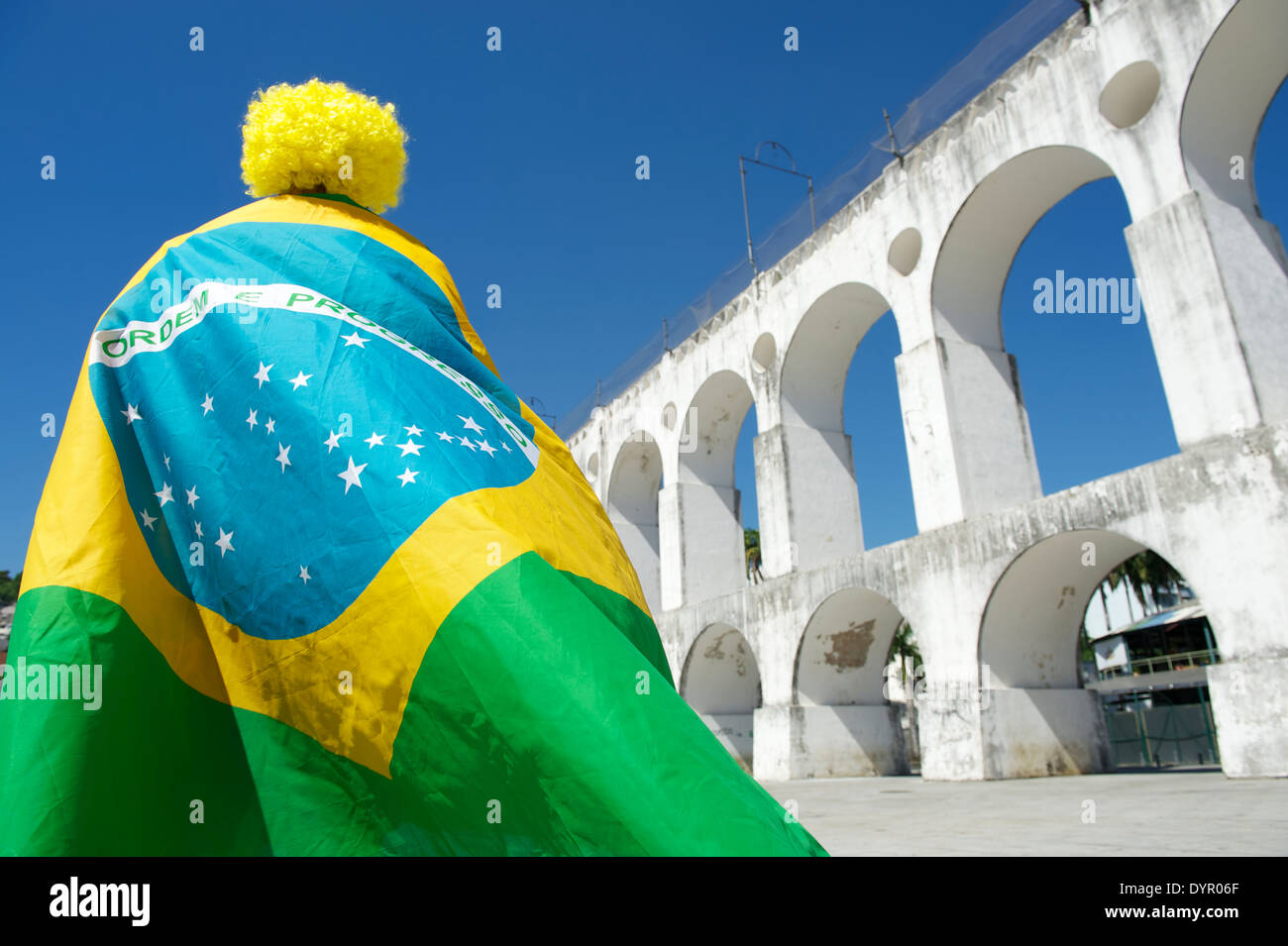 Brazilian man wearing Brazil flag and yellow wig at Arcos da Lapa ...