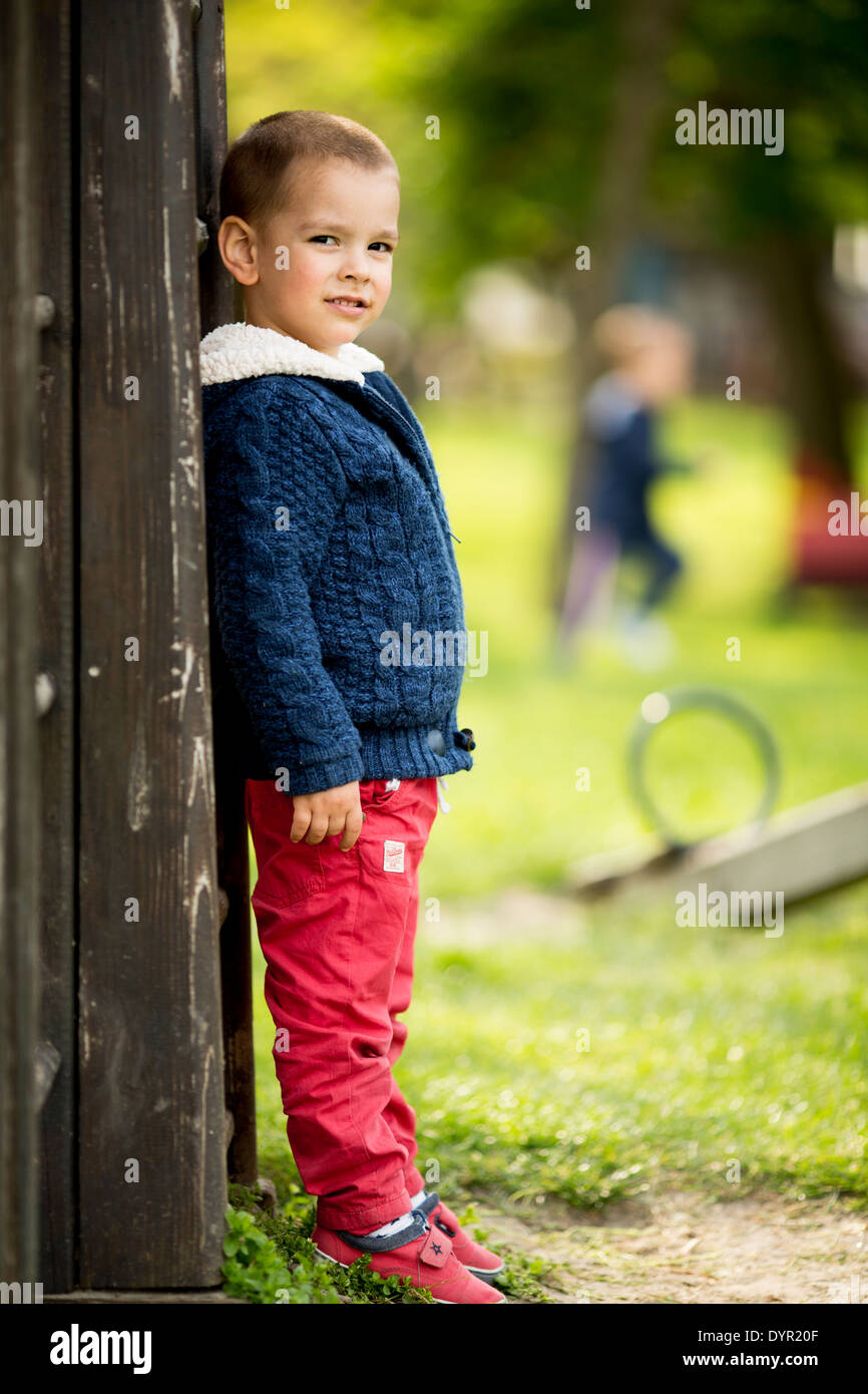 Cute boy by the tree Stock Photo - Alamy