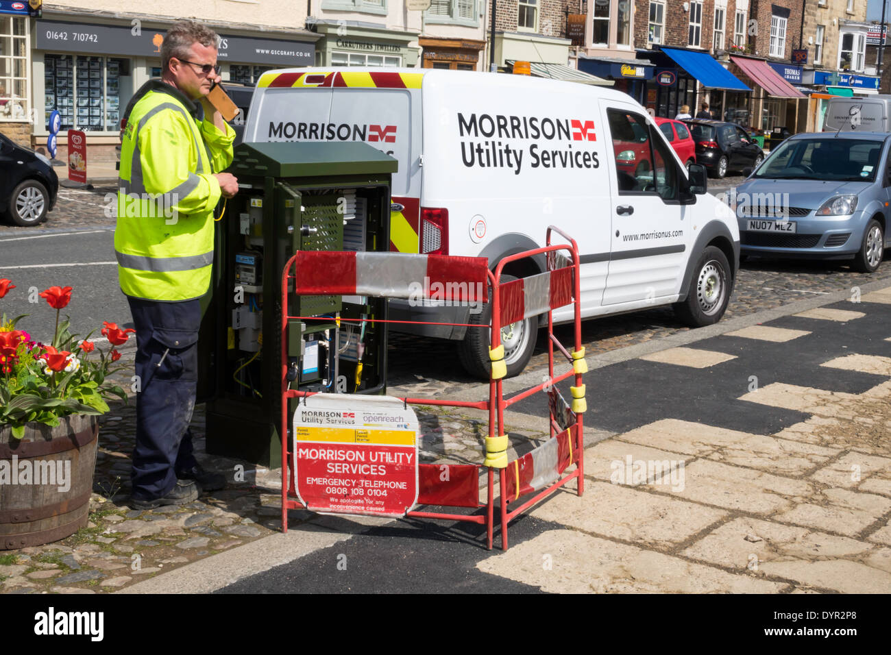 Telecommunications technician working on a broadband connection in a ...
