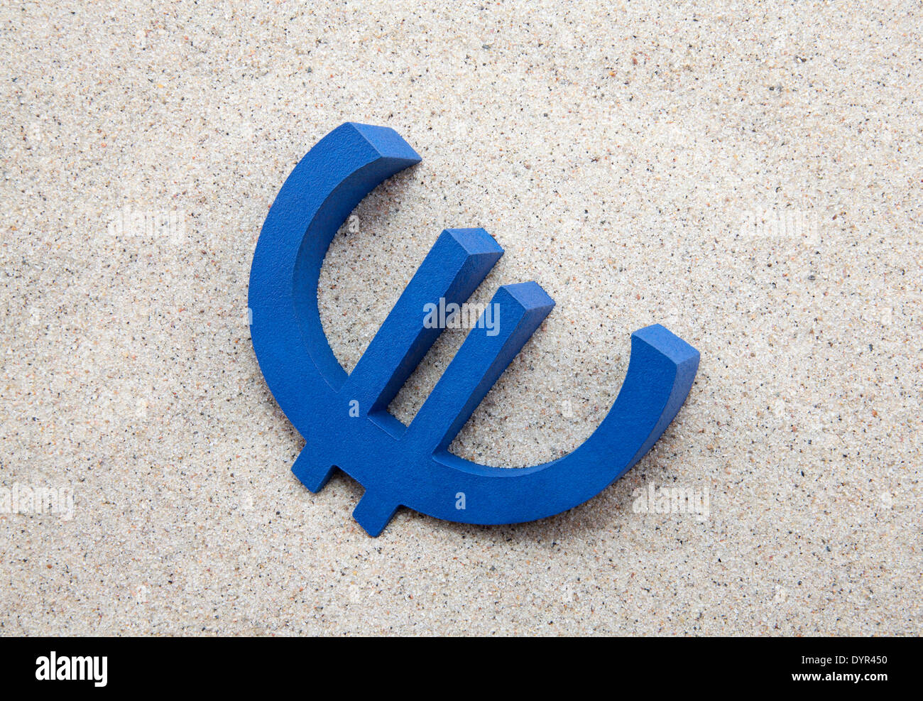 Blue euro symbol in the sand Stock Photo - Alamy