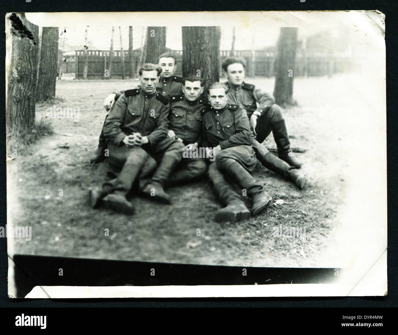 USSR - CIRCA 1953: Postcard shows five soldiers sitting under a tree ...