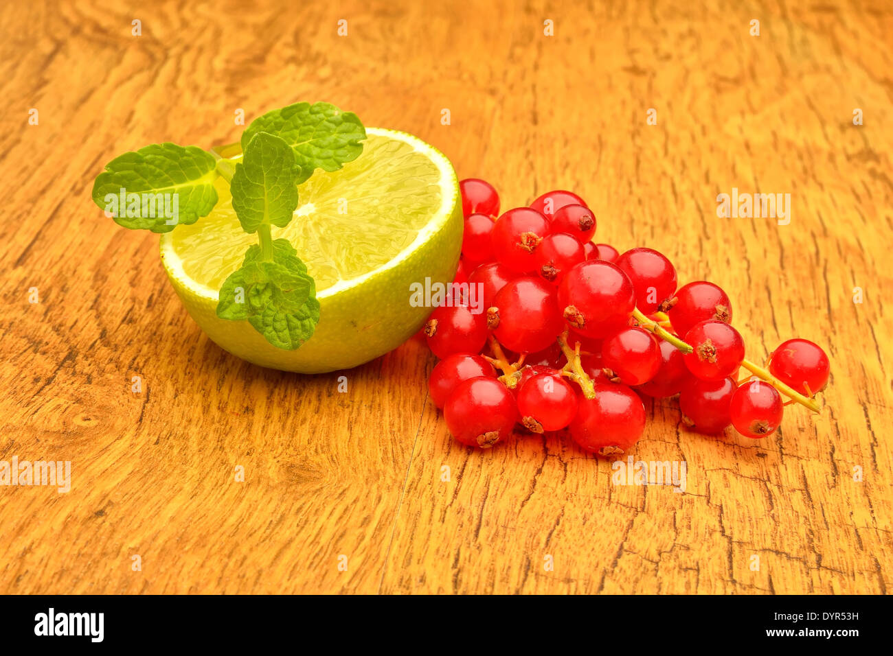 Slice of lime and red currant Stock Photo - Alamy