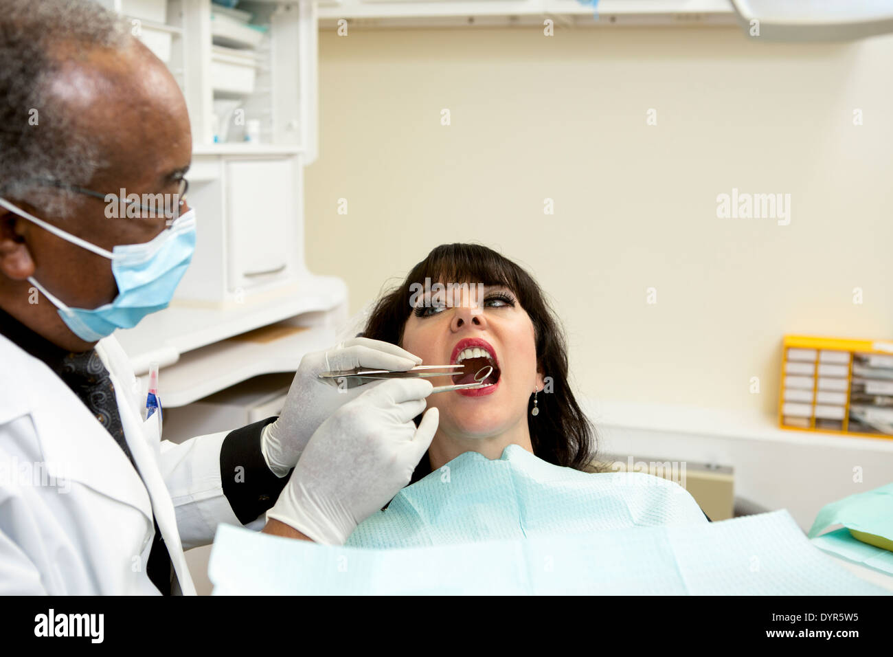 African American dentist beginning oral exam Stock Photo - Alamy