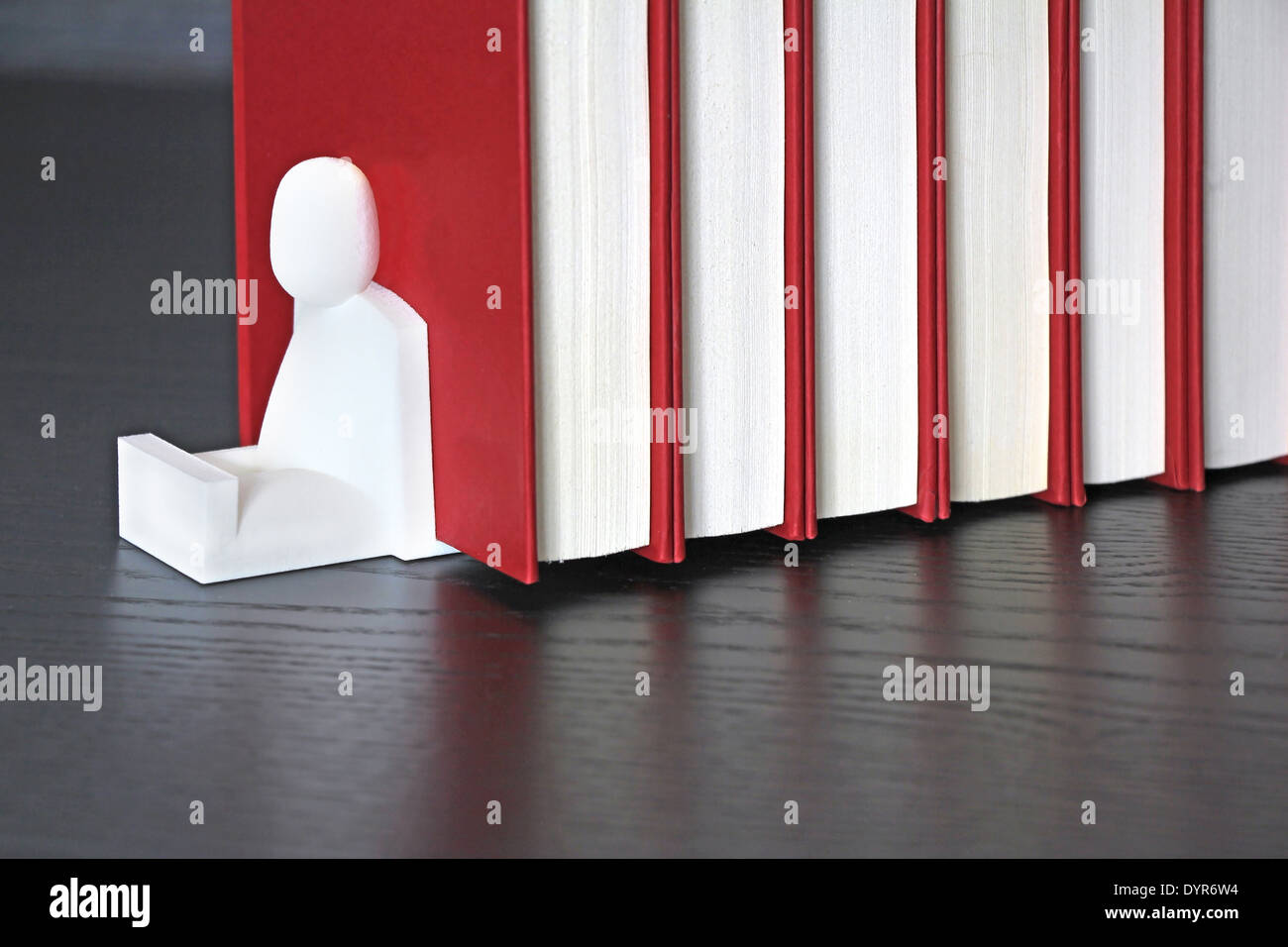 A pile of red books on a wooden shelf Stock Photo - Alamy
