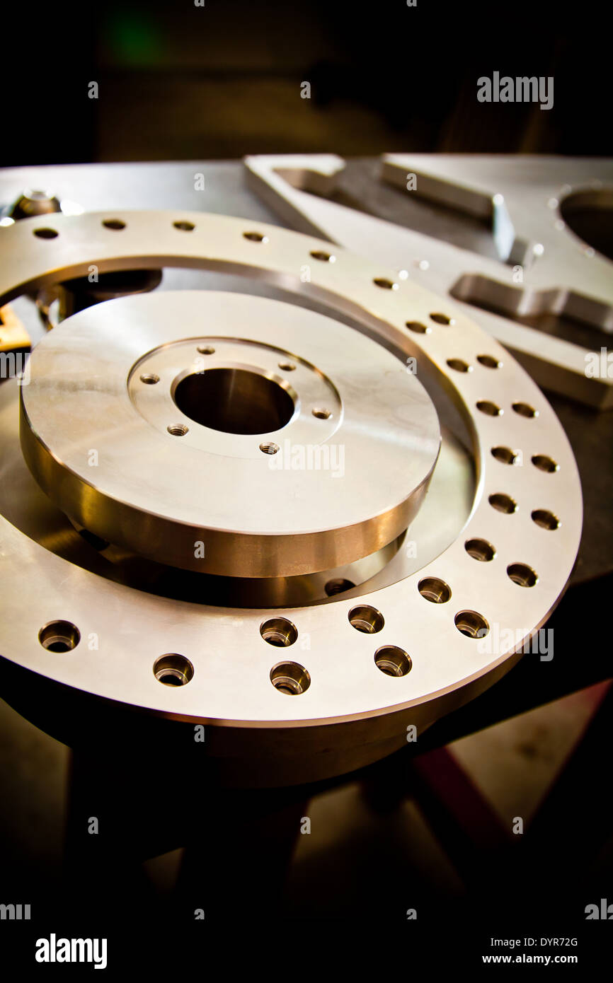 Custom-milled machine part made with CNC machine. Focus on foreground ...