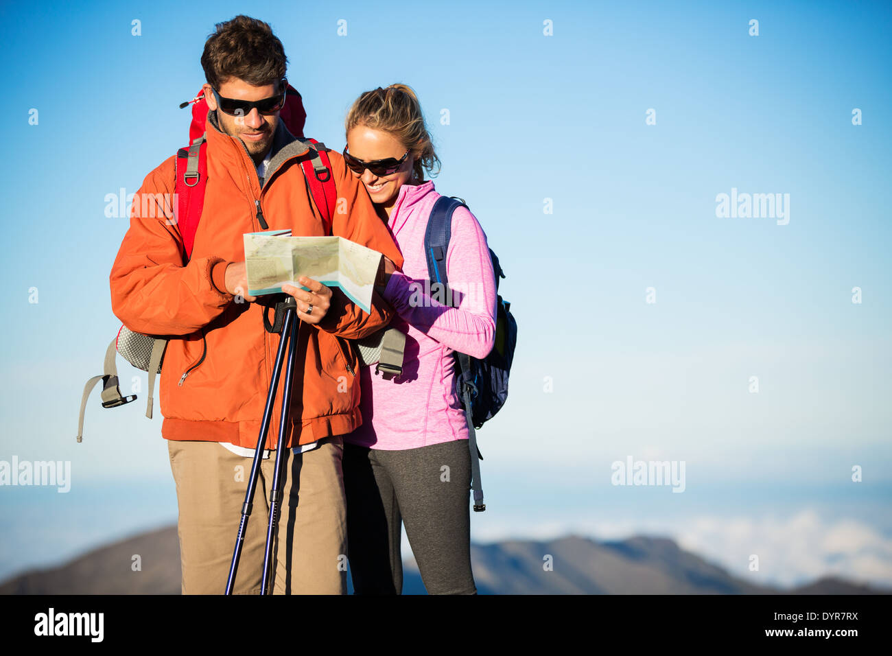 Hikers looking at trail map. Hiking in the mountains Stock Photo - Alamy