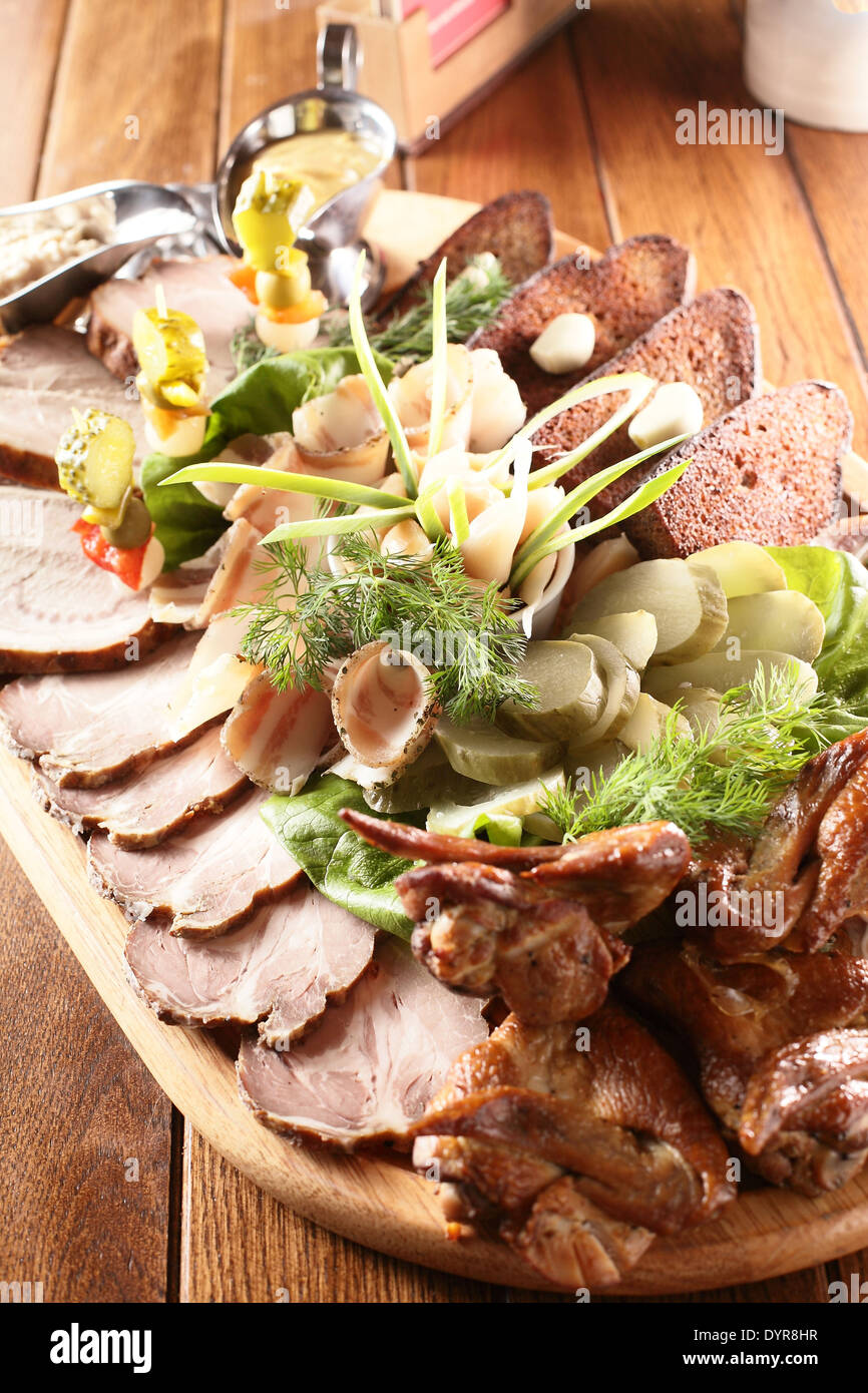 fresh and tasty peaces of meat with garnish Stock Photo - Alamy