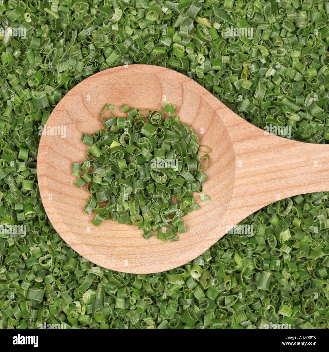 Dried chives on a kitchen spoon forming a background Stock Photo - Alamy