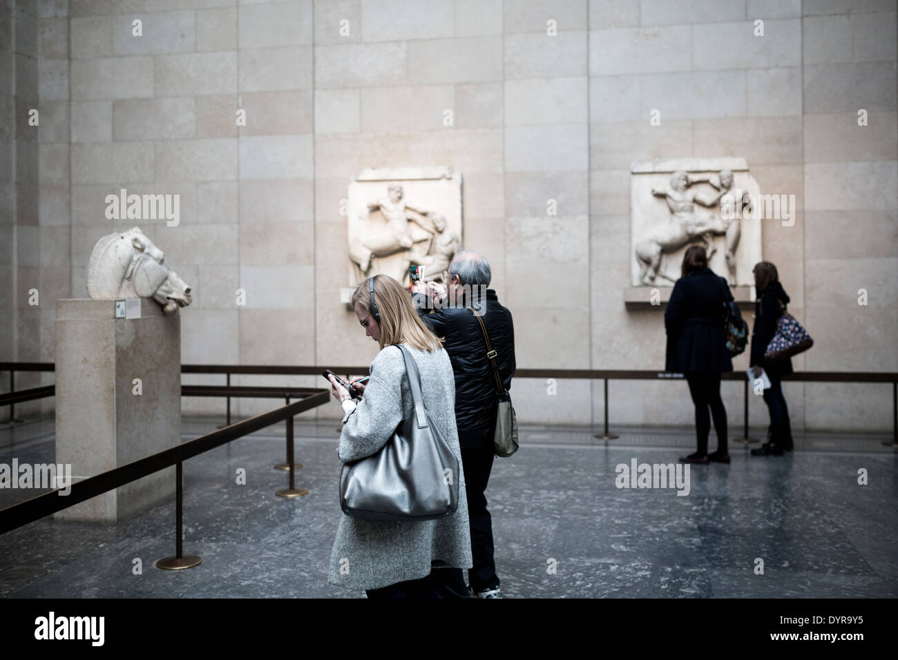 Tourists in front of Head of a horse of Selene from the east pediment ...