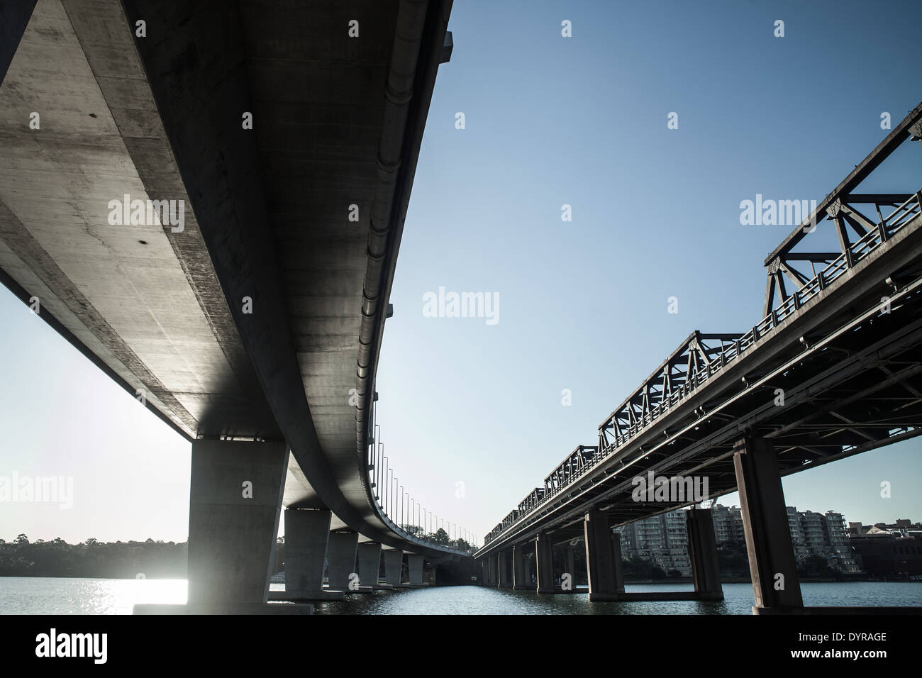 A older iron road bridge next to a modern concrete one in Sydney Stock ...
