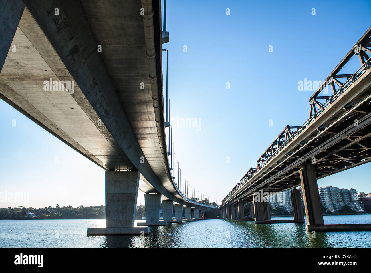 A older iron road bridge next to a modern concrete one in Sydney Stock ...