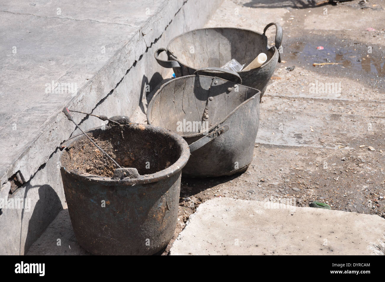 Three buckets by the kerb in a small Chinese village Stock Photo - Alamy