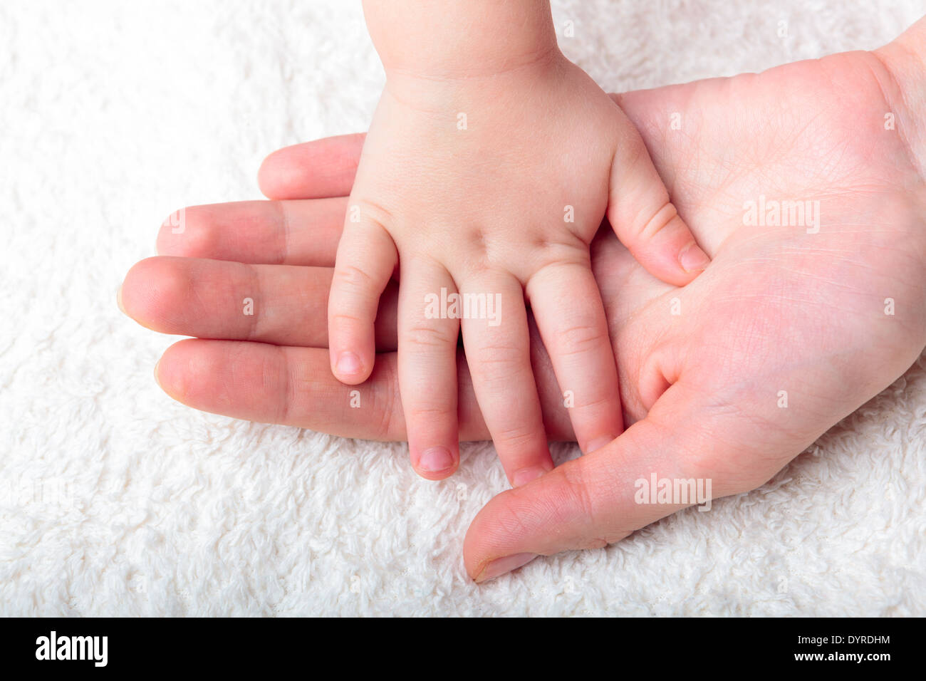 Mother's hand holding newborn baby's hand Stock Photo - Alamy