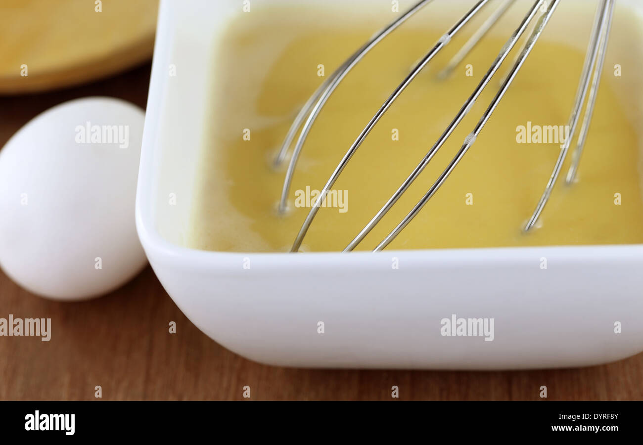 Egg beater in a kitchen with cooking ingredients Stock Photo - Alamy