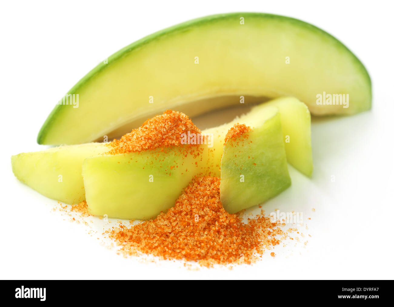 Fresh green mango with table salt mixed with ground chili over white ...