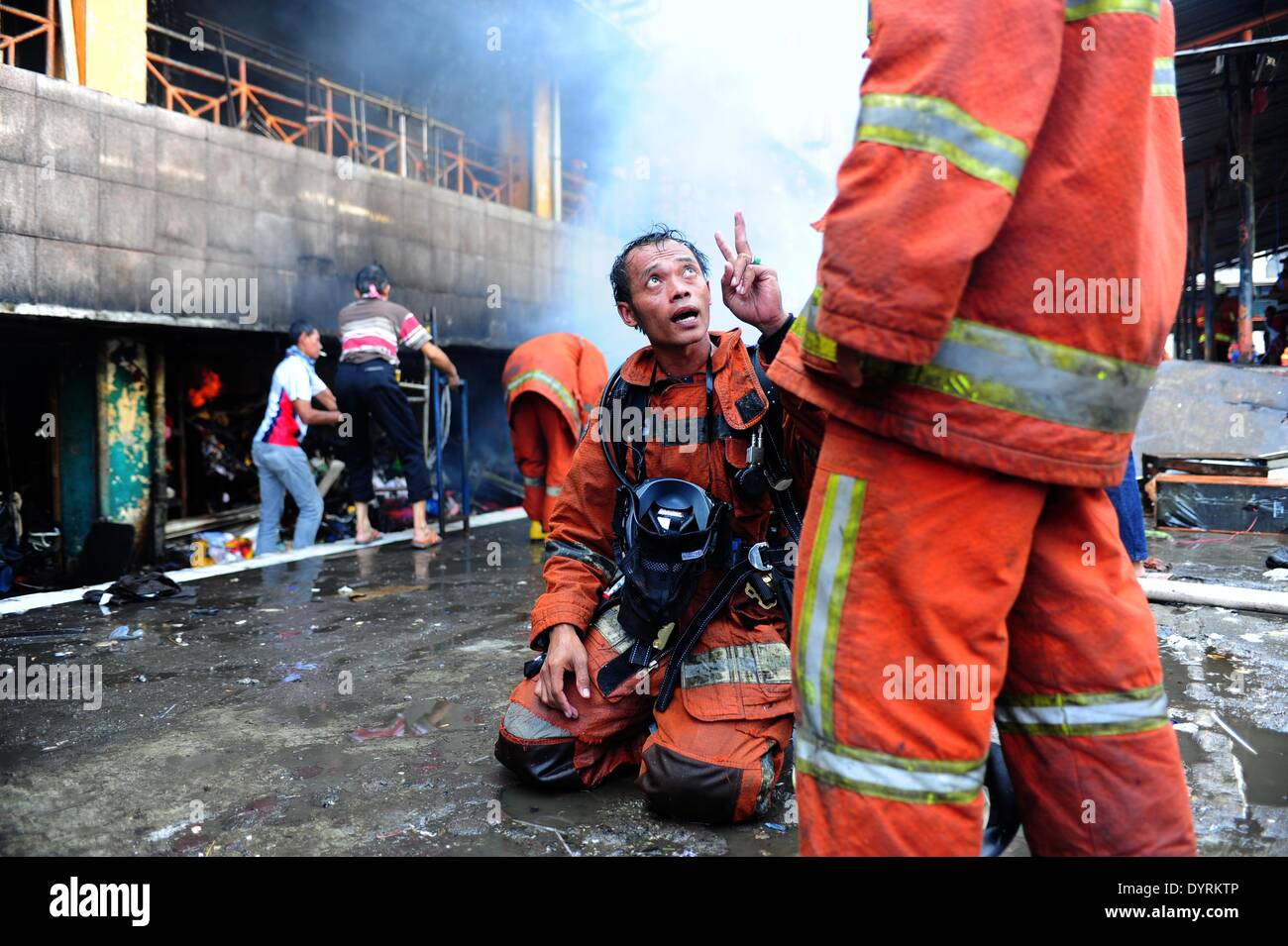 Jakarta, Indonesia. 25th Apr, 2014. An Indonesian firefighter sits on ...