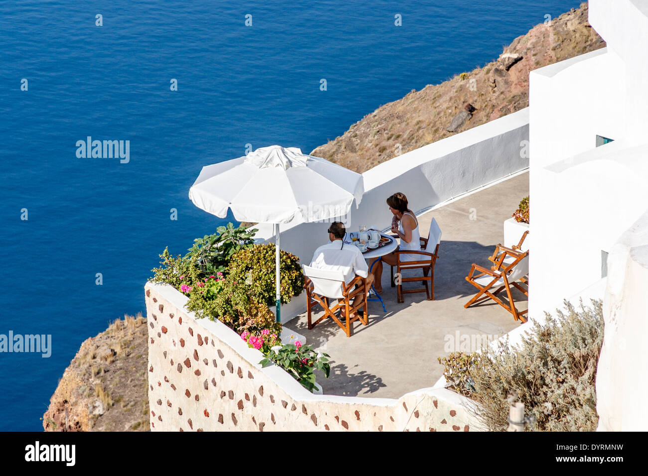 A Couple Eating Breakfast On A Terrace, Oia, Santorini, Greek Islands ...