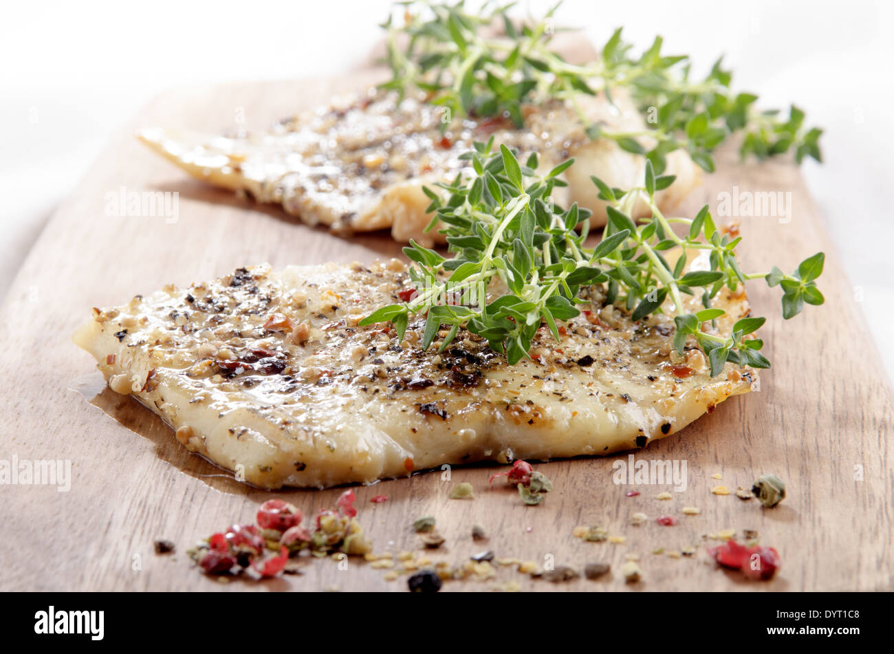 grilled cod with fresh thyme and pepper on a wooden board Stock Photo ...