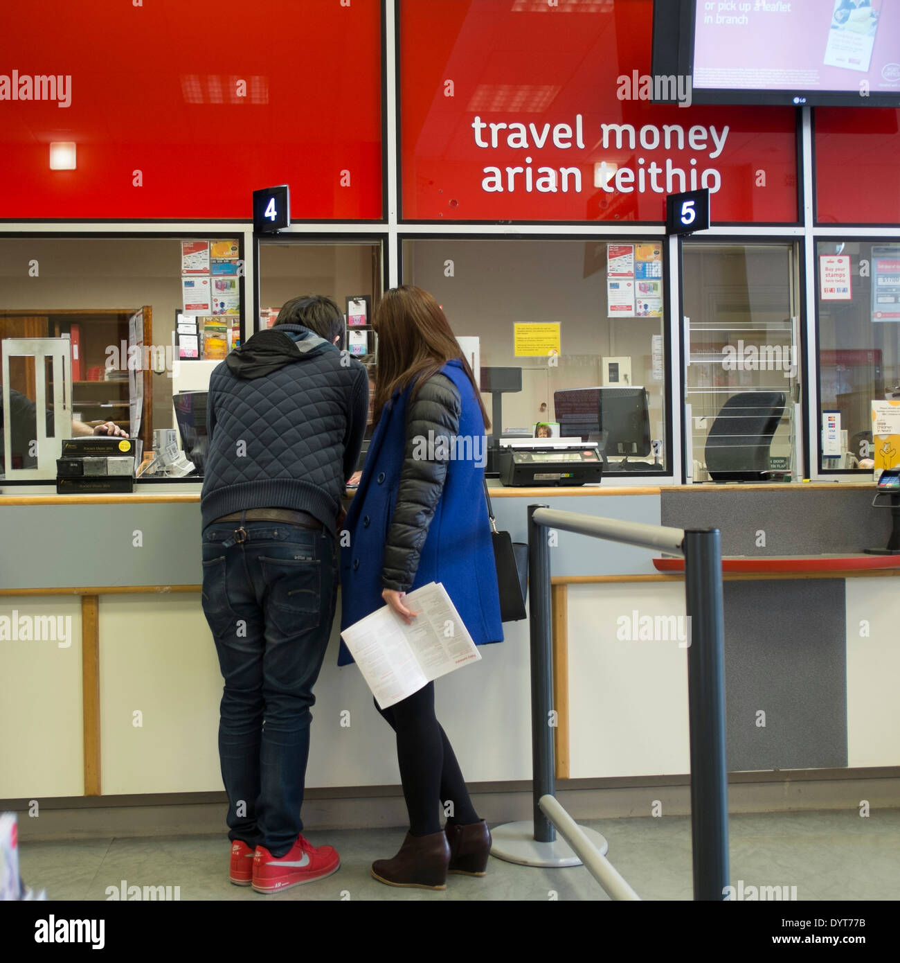 Two people at a Post Office counter, UK Stock Photo - Alamy