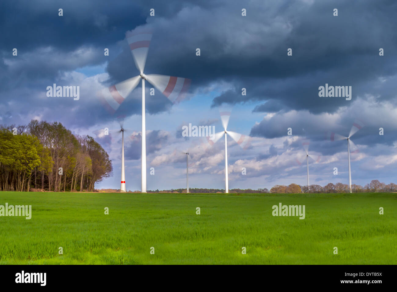 moving windmill powerplants on a green meadow Stock Photo - Alamy